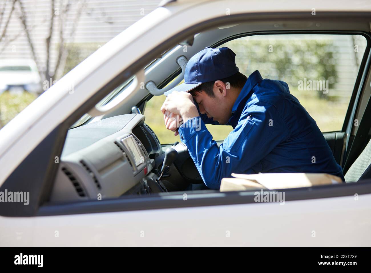 Japanese delivery man sitting in the driver seat Stock Photo - Alamy