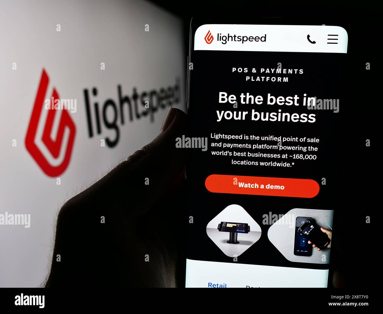 Person holding cellphone with website of Canadian retail platform ...