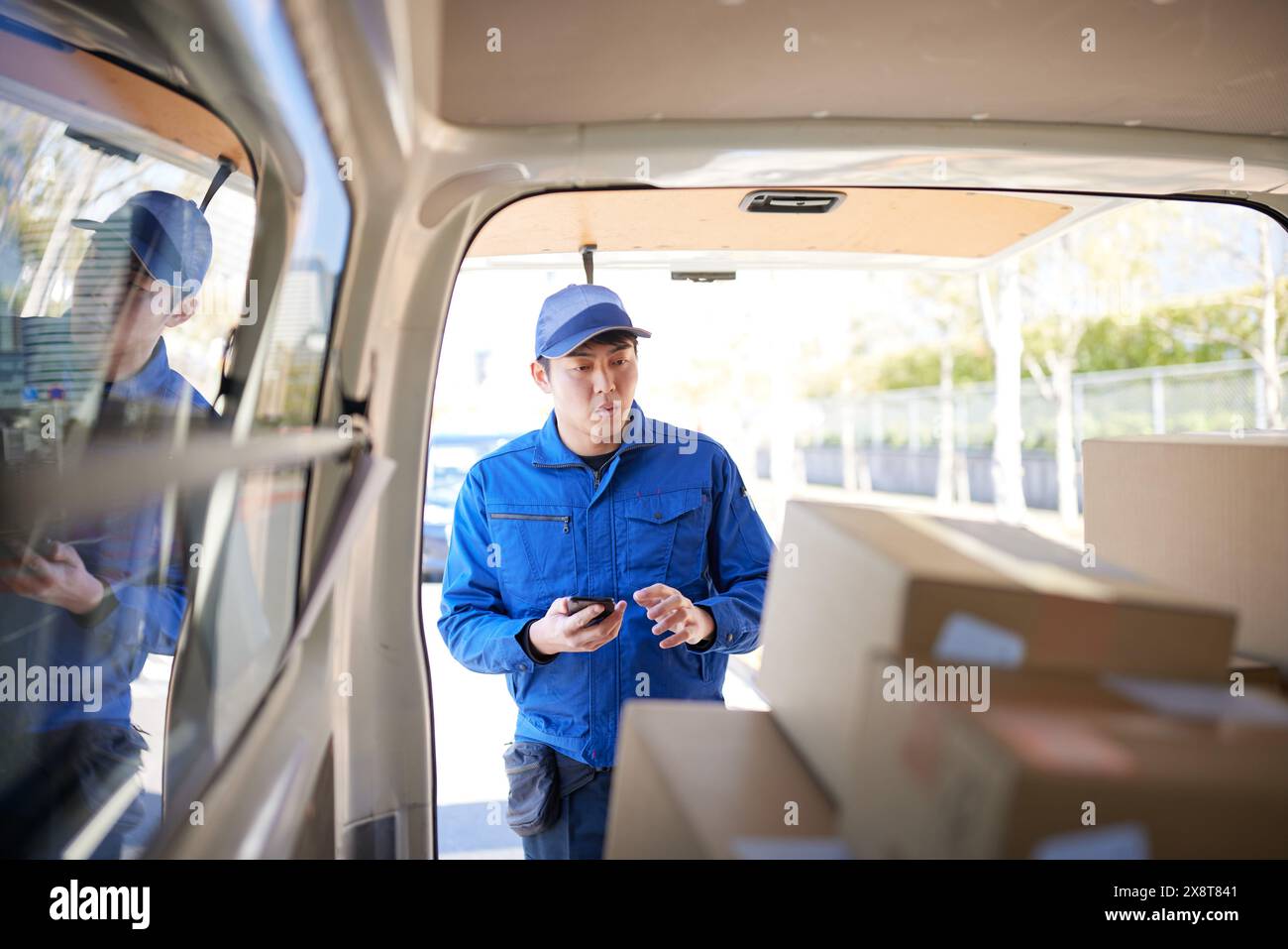Japanese delivery man checking boxes in the car Stock Photo - Alamy