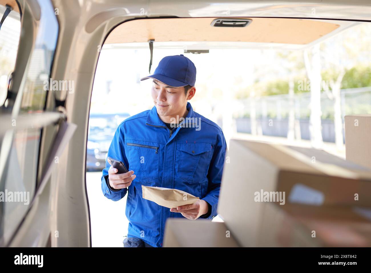 Japanese delivery man checking boxes in the car Stock Photo - Alamy