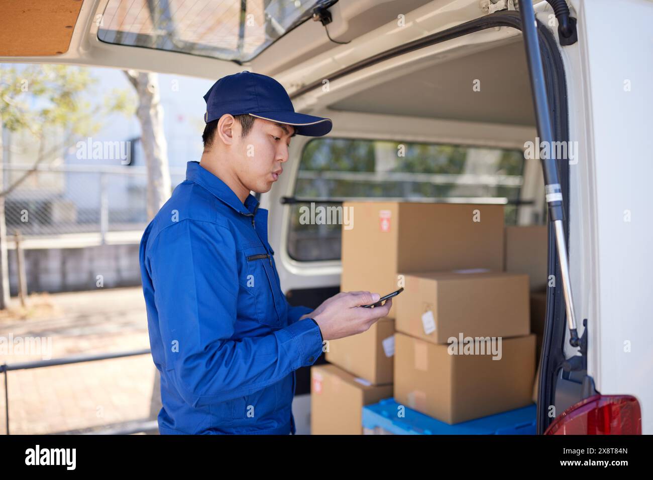 Japanese delivery man checking boxes in the car Stock Photo - Alamy