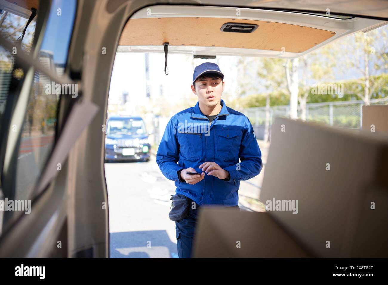 Japanese delivery man checking boxes in the car Stock Photo - Alamy