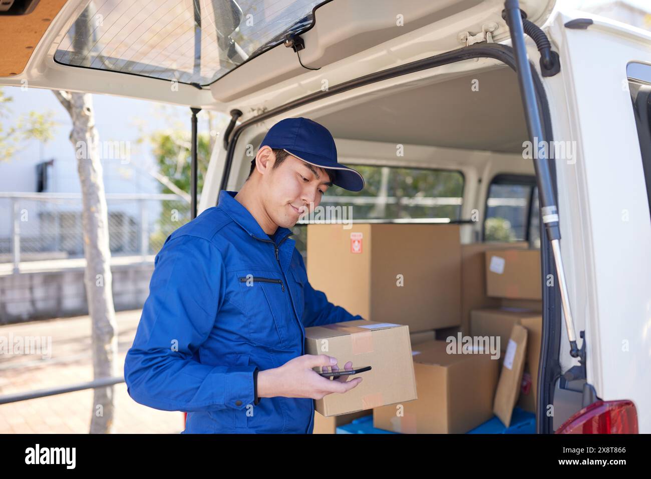 Japanese delivery man checking boxes in the car Stock Photo - Alamy