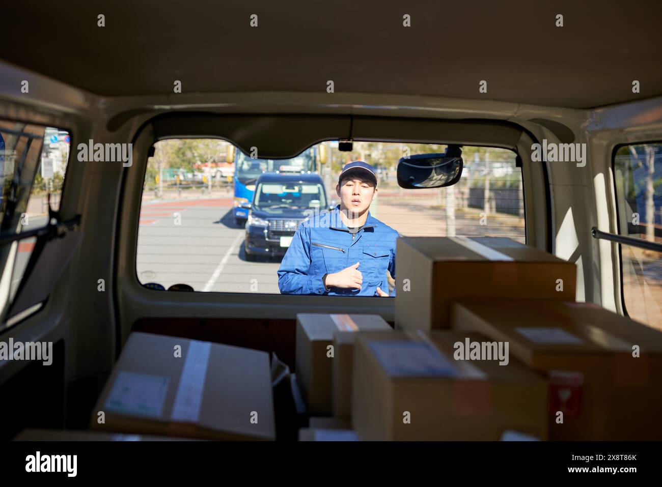 Japanese delivery man checking boxes in the car Stock Photo - Alamy