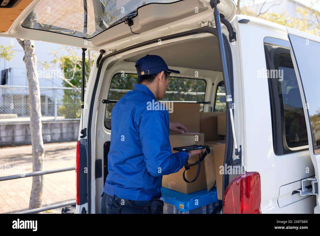 Japanese delivery man checking boxes in the car Stock Photo - Alamy