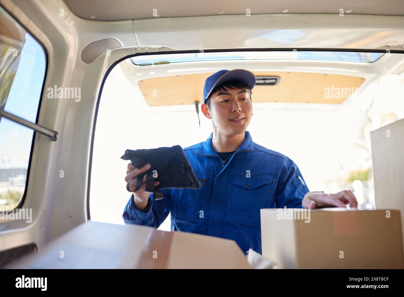 Japanese delivery man checking boxes in the car Stock Photo - Alamy