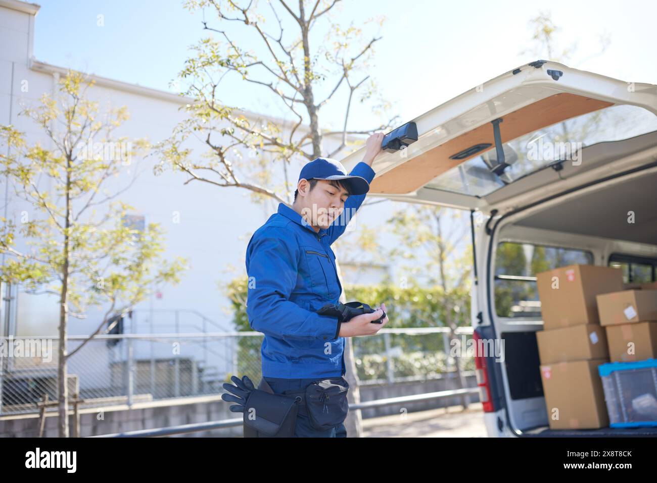 Japanese delivery man checking boxes in the car Stock Photo - Alamy