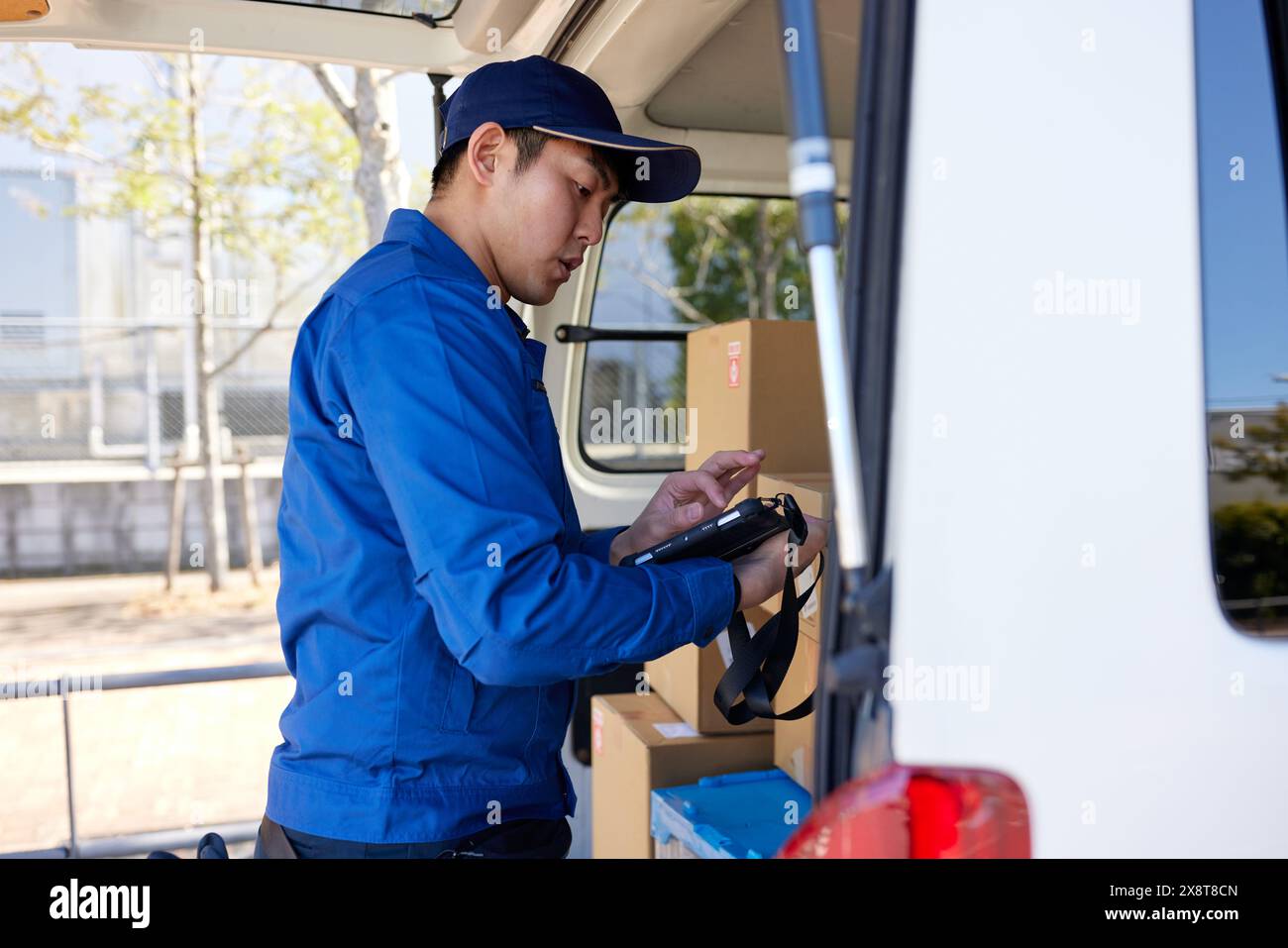 Japanese delivery man checking boxes in the car Stock Photo - Alamy
