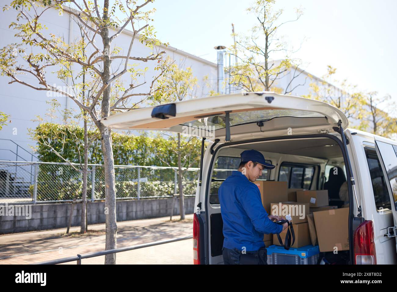 Japanese delivery man checking boxes in the car Stock Photo - Alamy