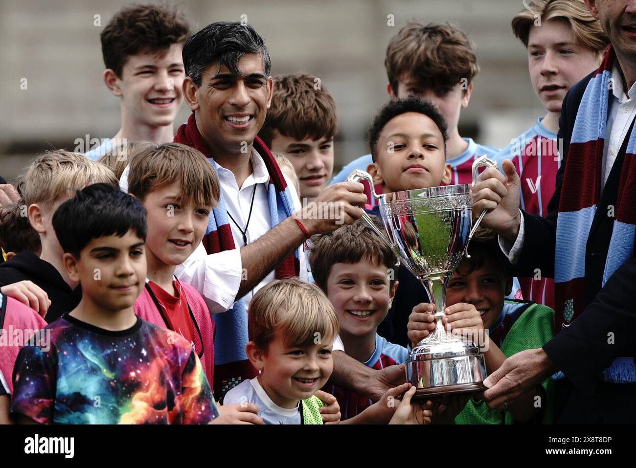 Prime Minister Rishi Sunak holds the cup of newly promoted Chesham ...