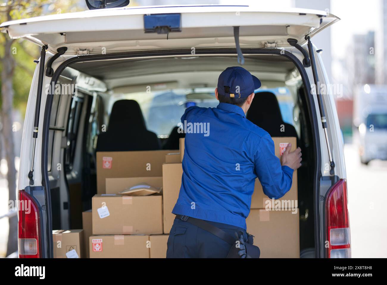 Japanese delivery man checking boxes in the car Stock Photo - Alamy