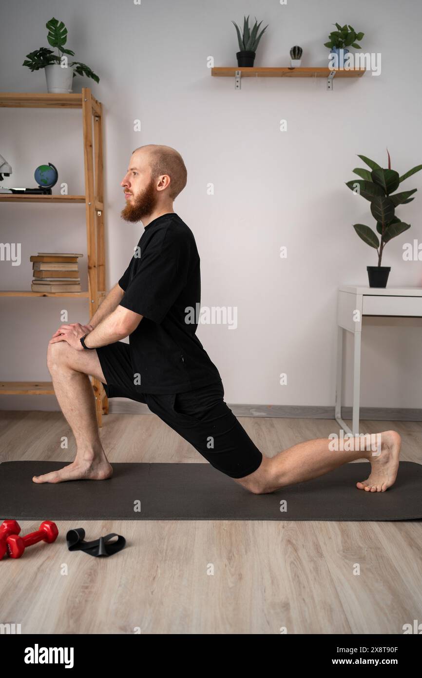 active male doing sports home. healthy body. exercise to strengthen leg ...
