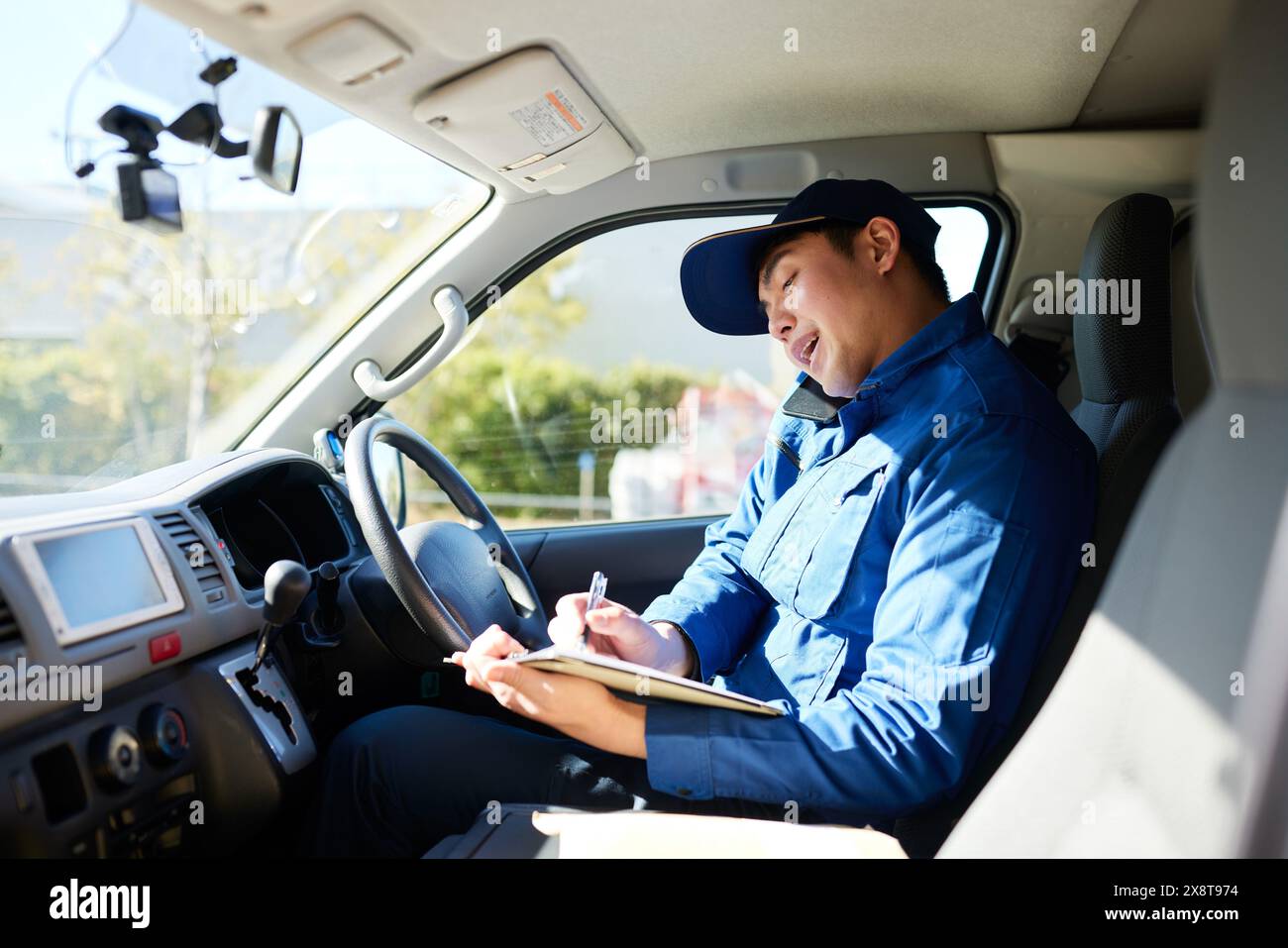 Japanese delivery man sitting in the driver seat Stock Photo - Alamy