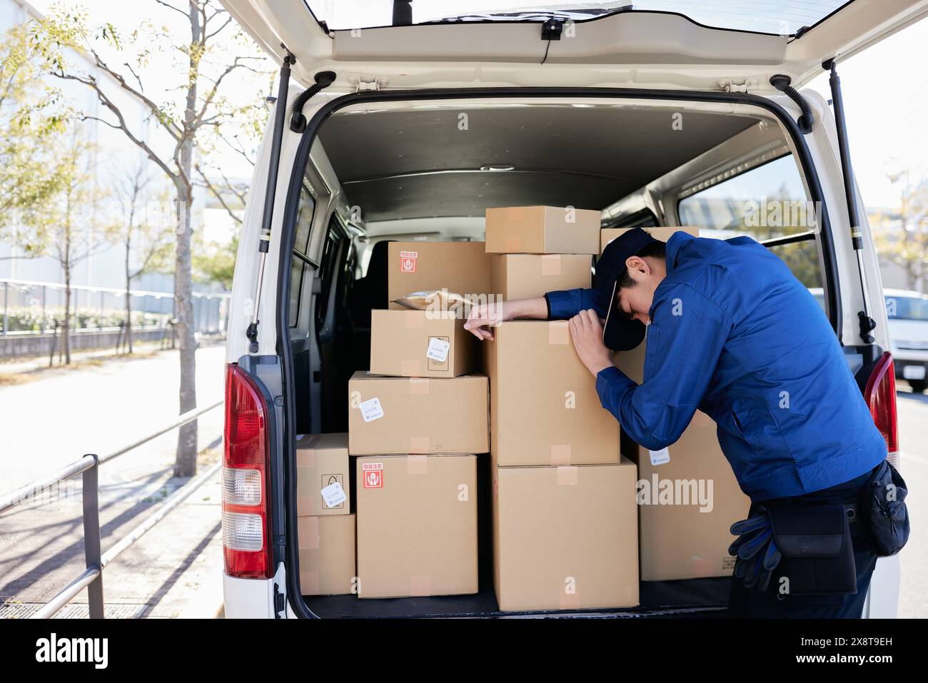 Japanese delivery man checking boxes in the car Stock Photo - Alamy