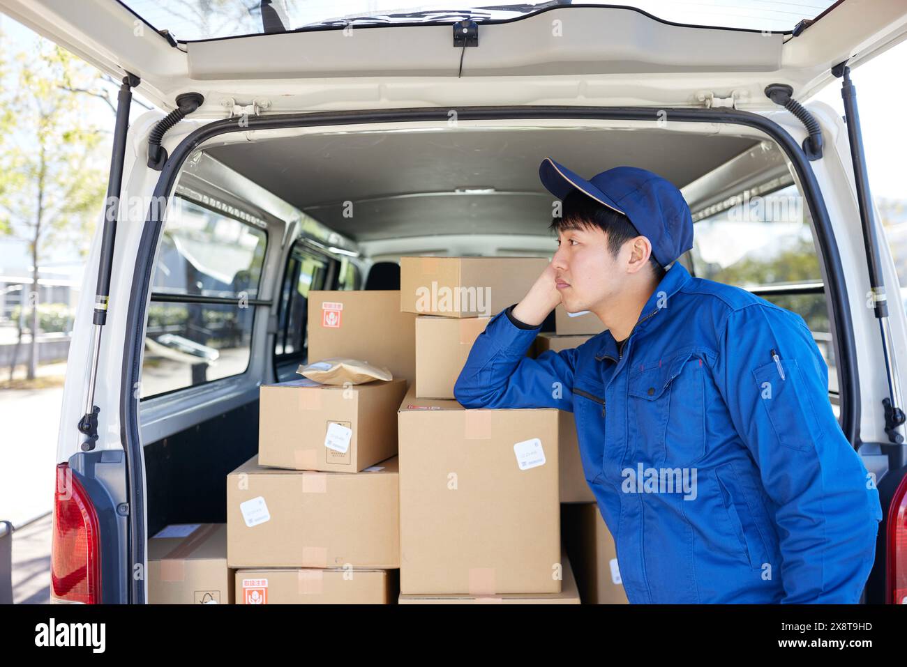 Japanese delivery man checking boxes in the car Stock Photo - Alamy
