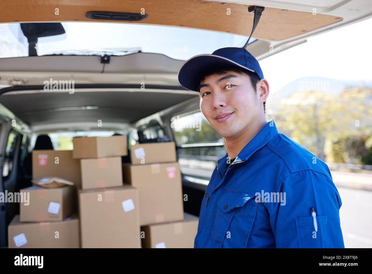 Japanese delivery man standing in front of a van with boxes Stock Photo ...