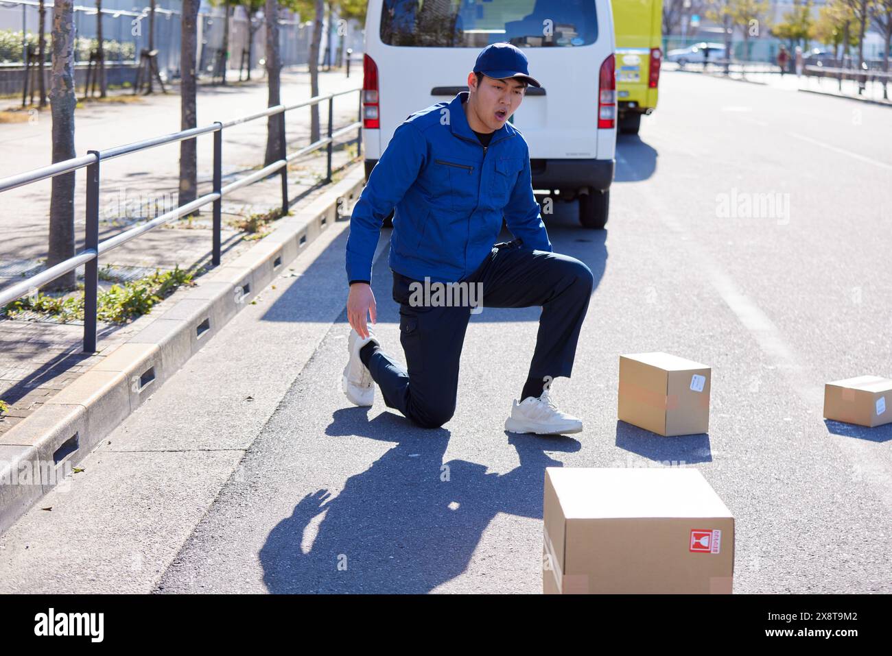 Japanese delivery man dropping boxes Stock Photo - Alamy