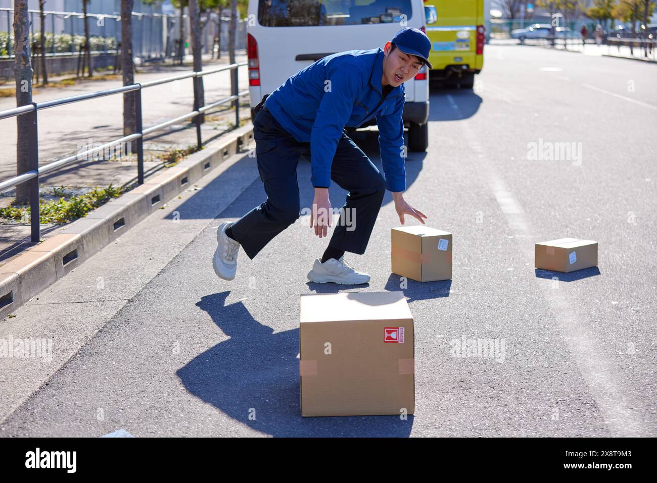 Japanese delivery man dropping boxes Stock Photo - Alamy