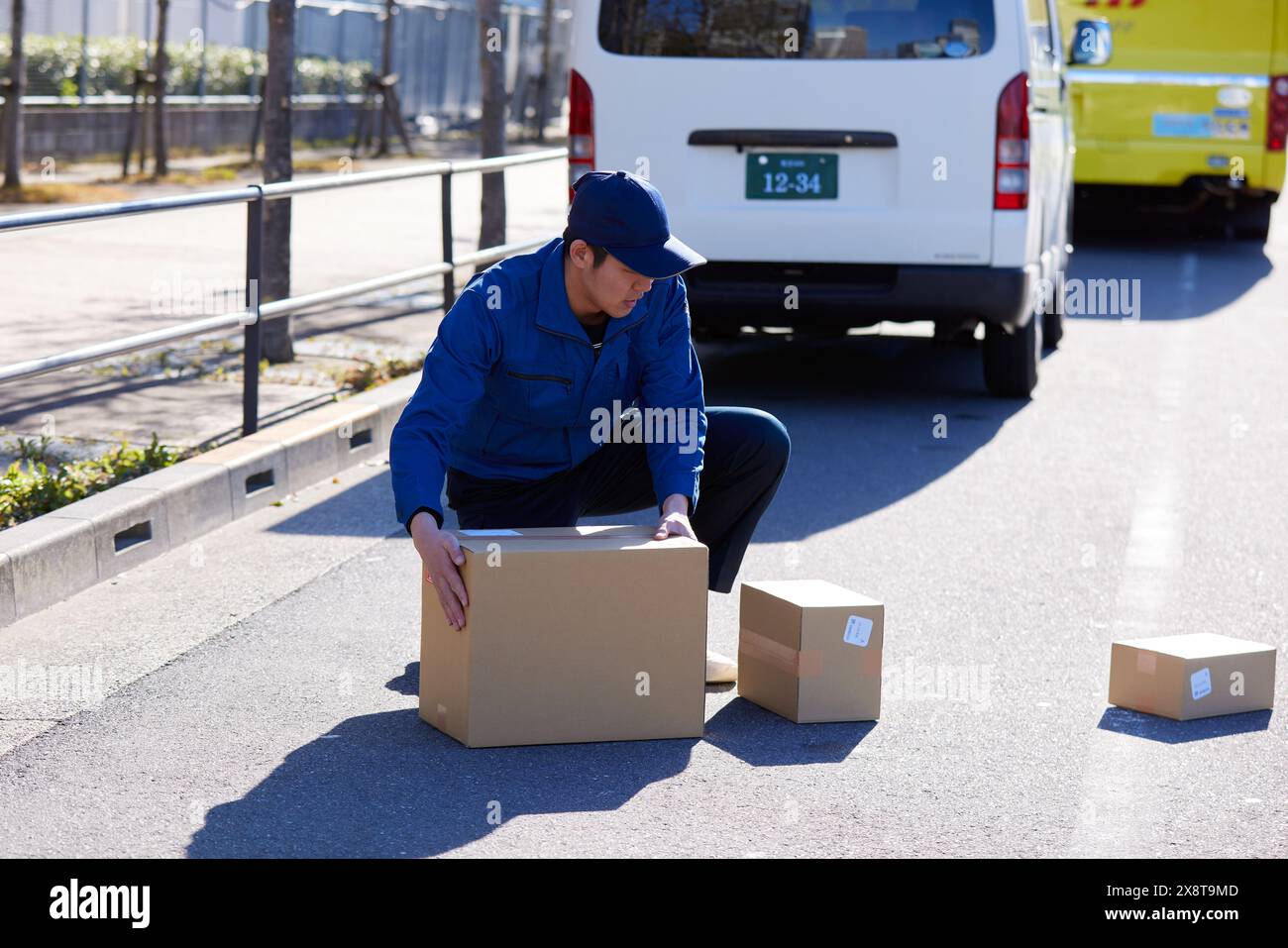 Japanese delivery man dropping boxes Stock Photo - Alamy