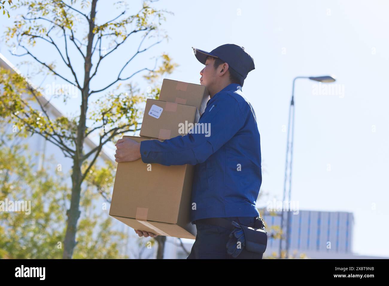 Japanese delivery man delivering boxes Stock Photo - Alamy