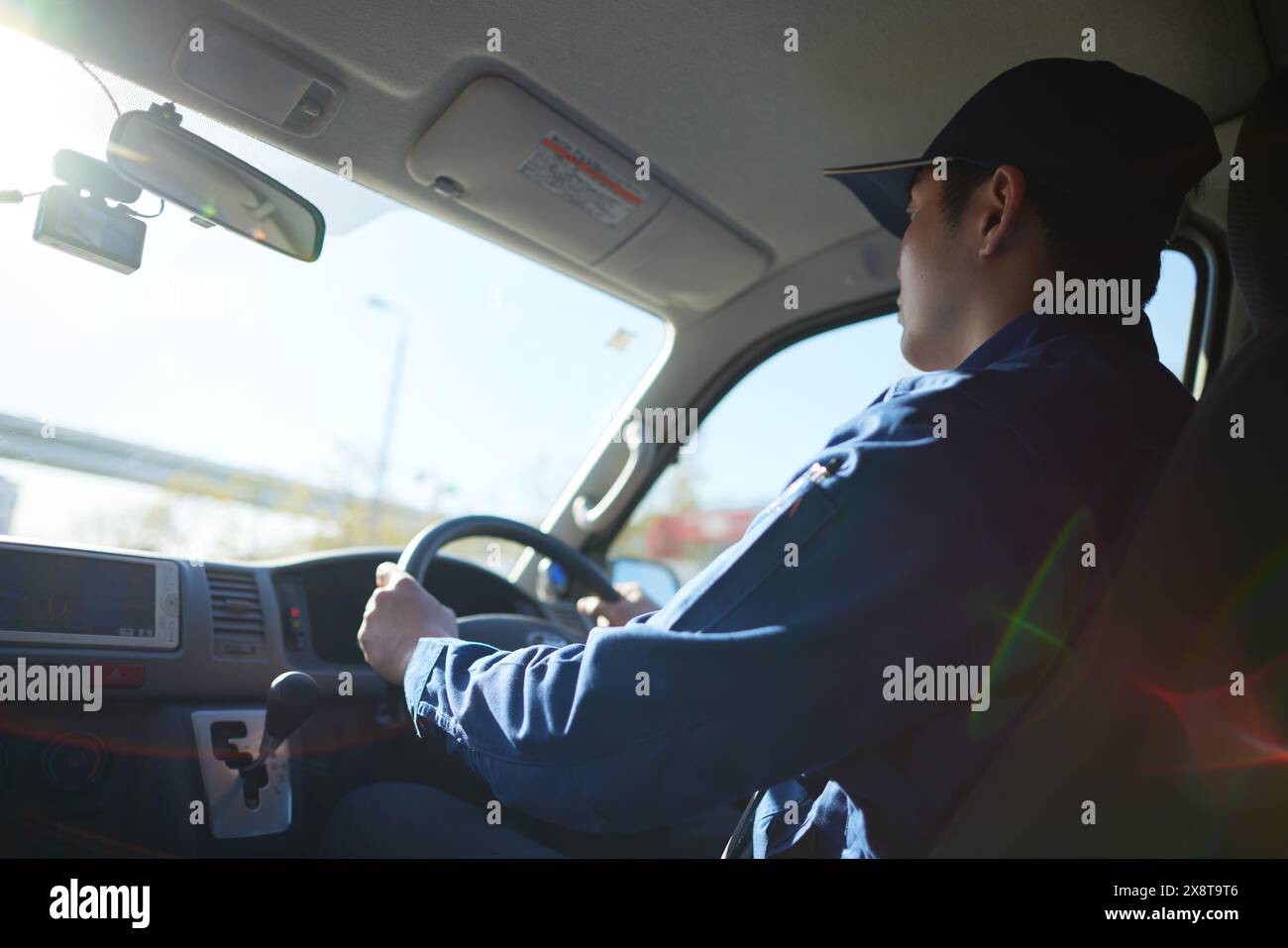 Japanese delivery man sitting in the driver seat Stock Photo - Alamy