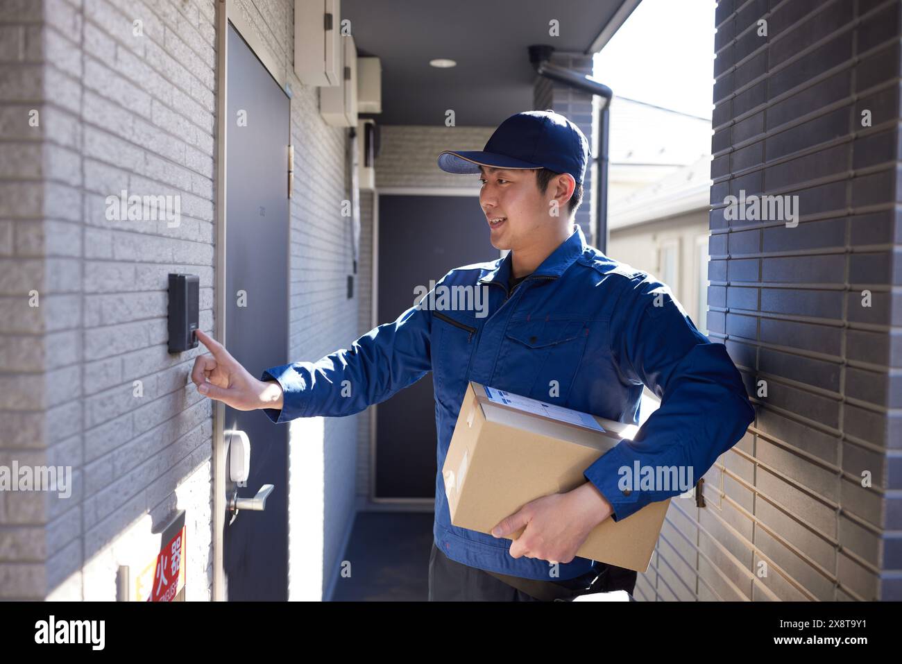 Japanese delivery man delivering boxes Stock Photo - Alamy