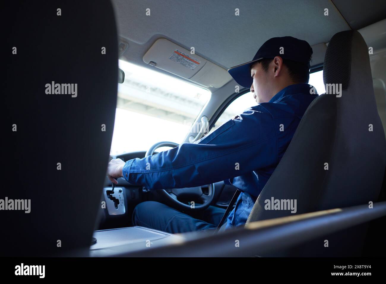 Japanese delivery man sitting in the driver seat Stock Photo - Alamy