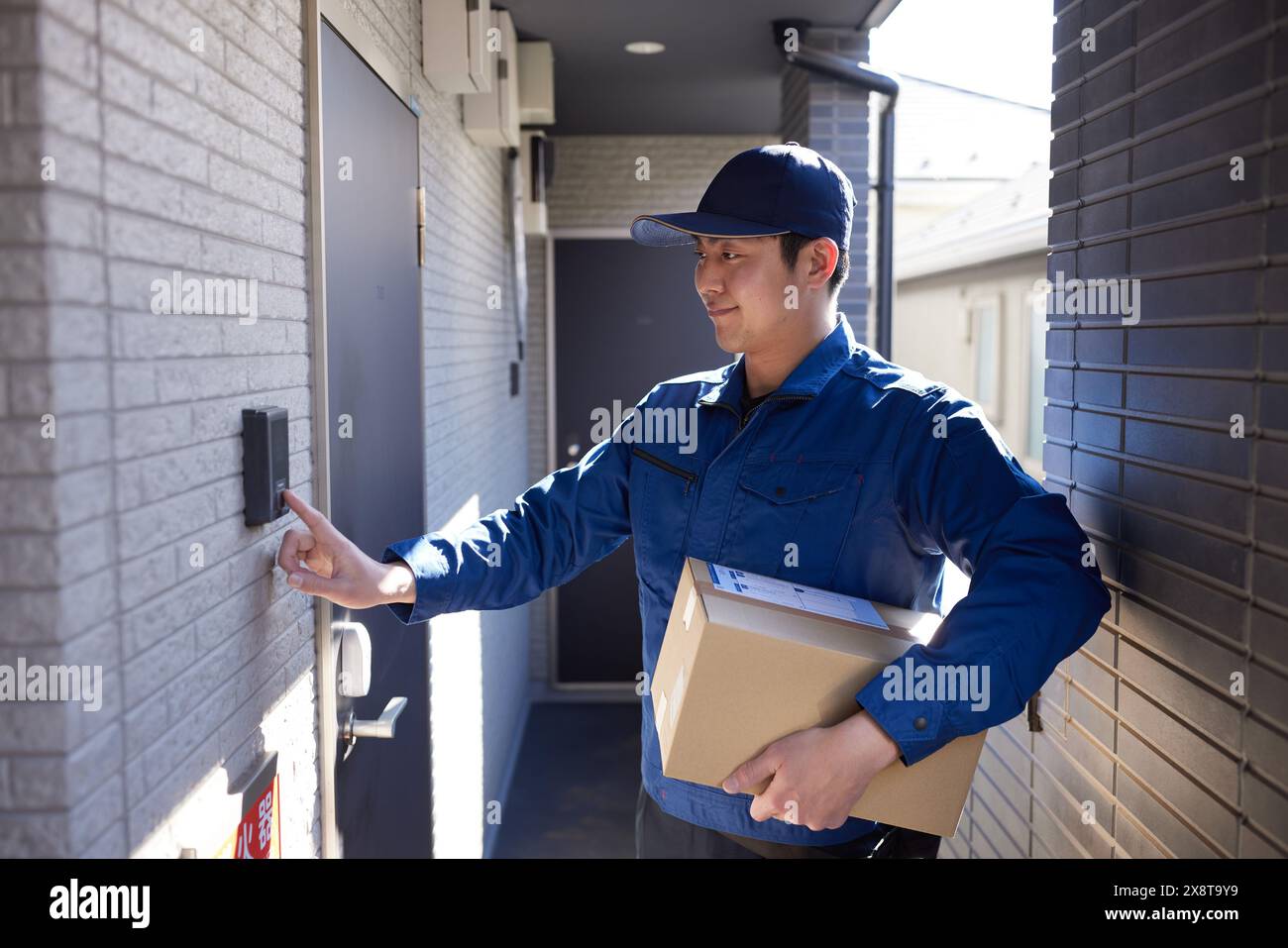 Japanese delivery man delivering boxes Stock Photo - Alamy