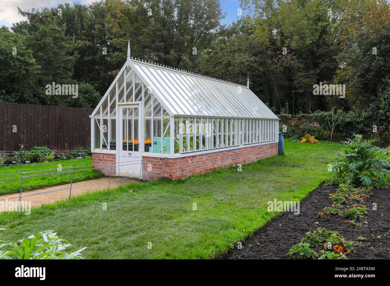 An old restored Victorian greenhouse at Speke Hall, a wood-framed ...