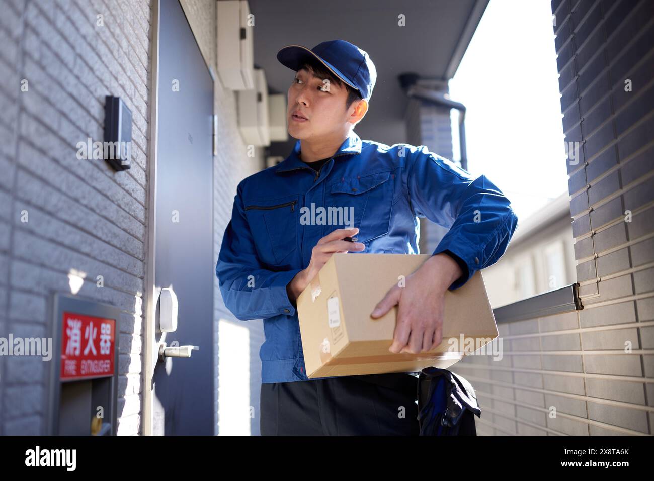 Japanese delivery man delivering boxes Stock Photo - Alamy