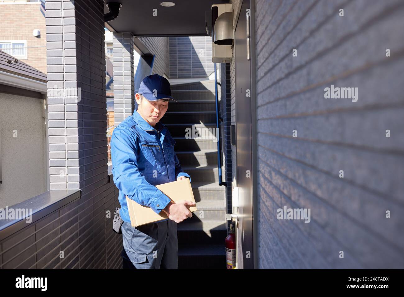 Japanese delivery man delivering boxes Stock Photo - Alamy