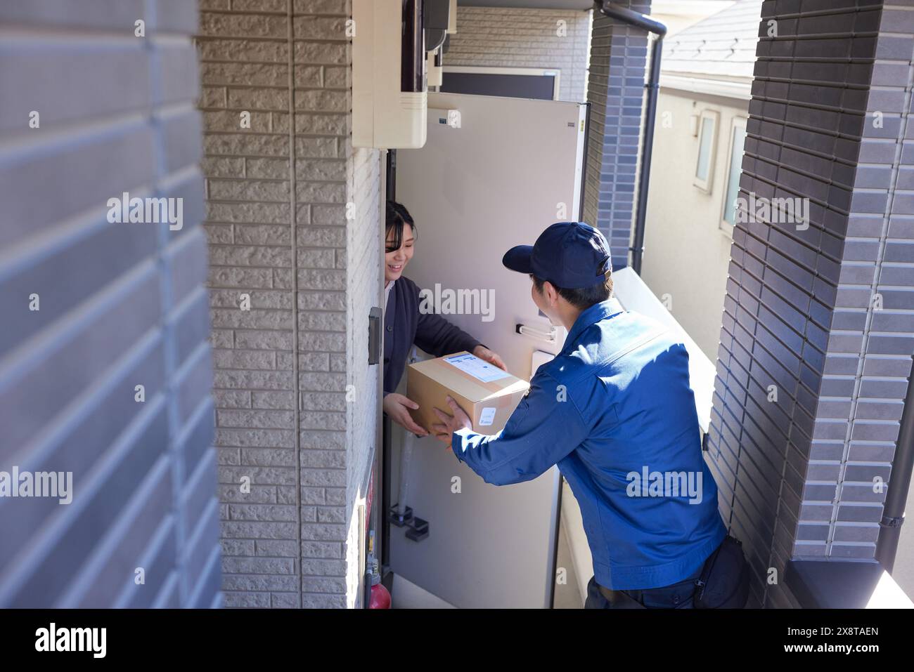 Japanese delivery man delivering boxes Stock Photo - Alamy