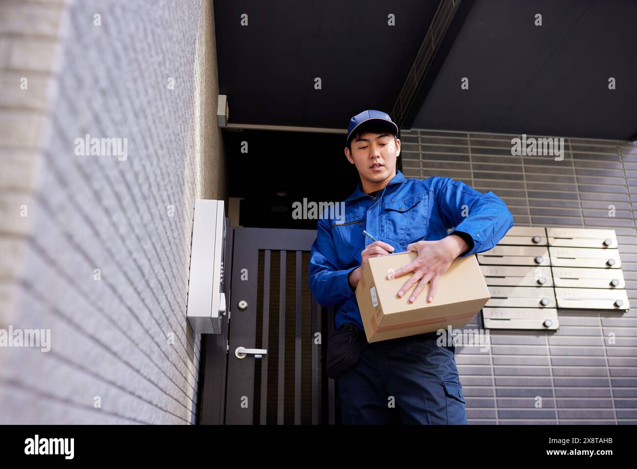 Japanese delivery man delivering boxes Stock Photo - Alamy