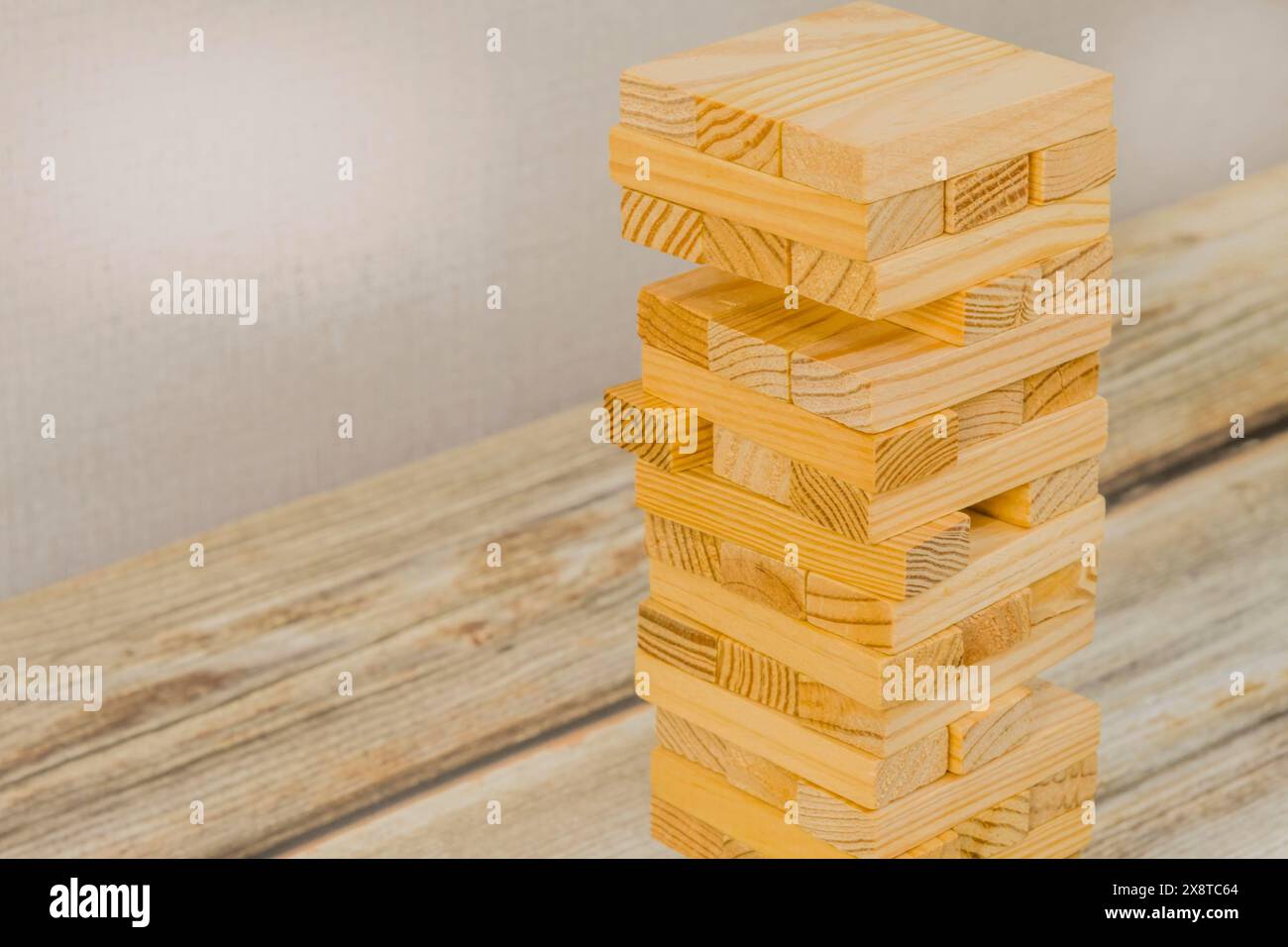 Closeup of tower of wooden blocks on a wooden tabletop. Generic version ...