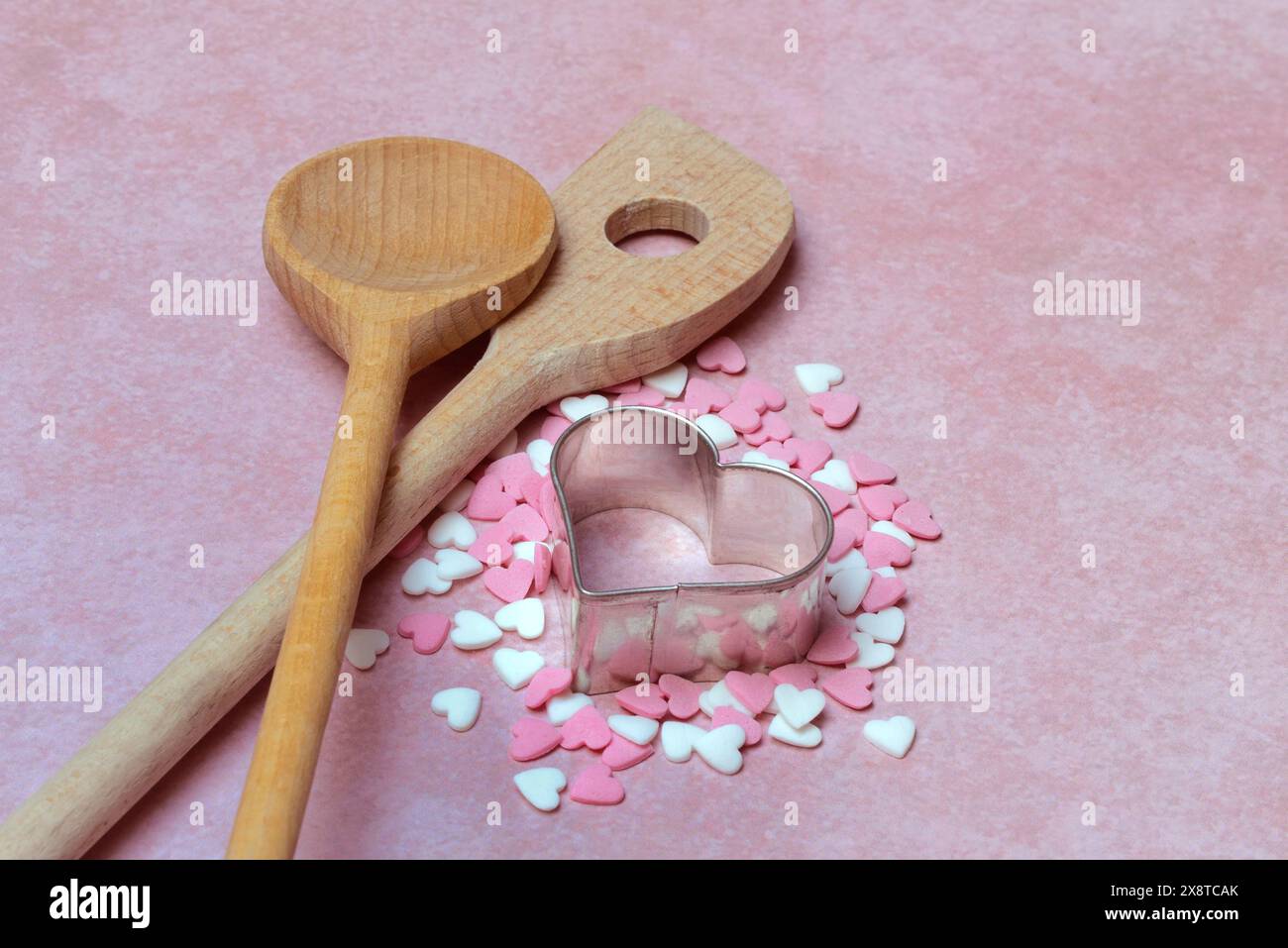 Cooking spoon and heart-shaped cookie cutter with sugar hearts Stock ...
