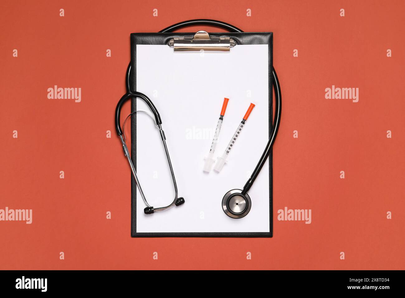 Stethoscope Syringes And Clipboard On Crimson Background Top View