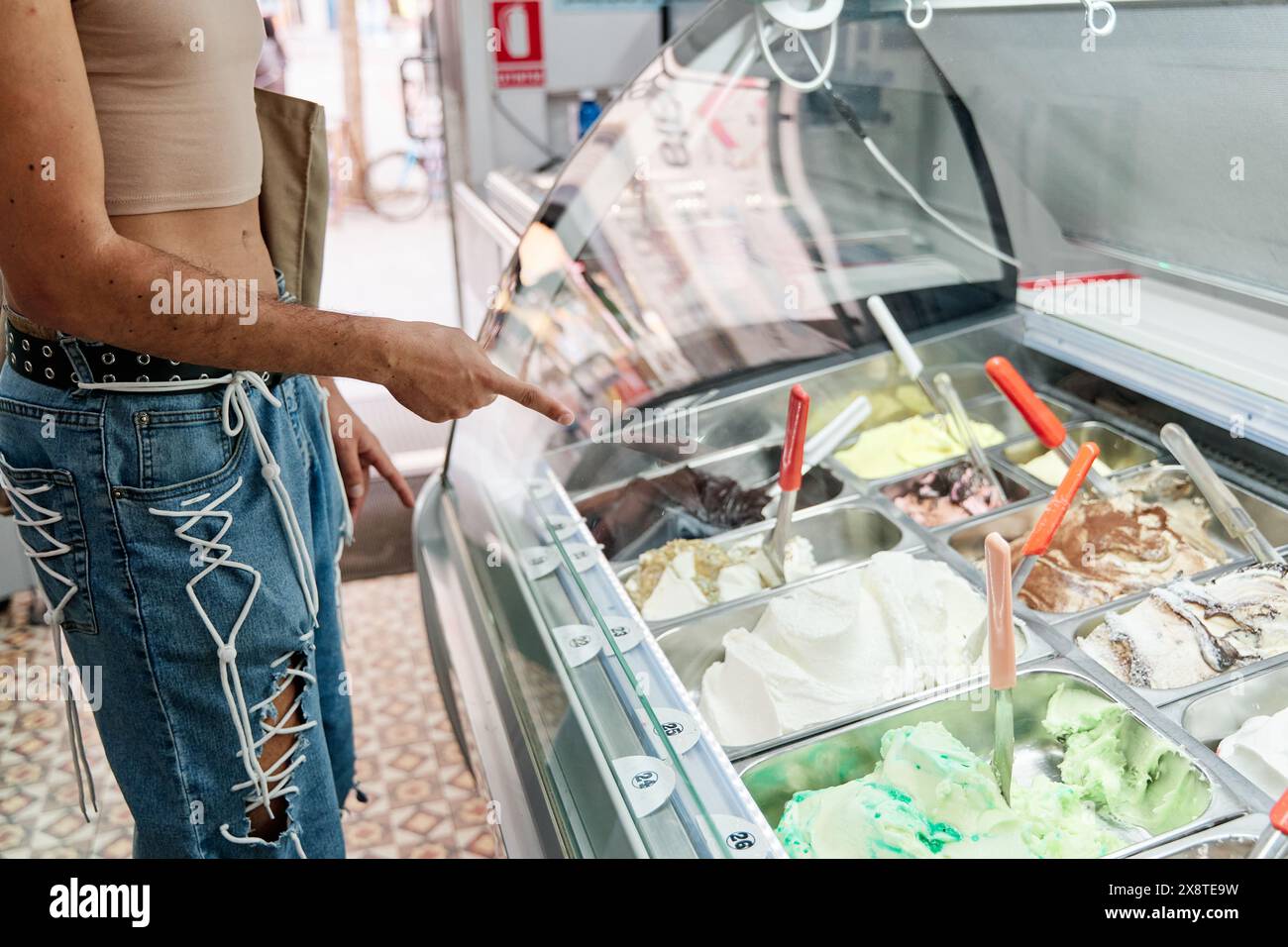 ice cream flavour selection. young Caucasian pointing to an ice cream ...