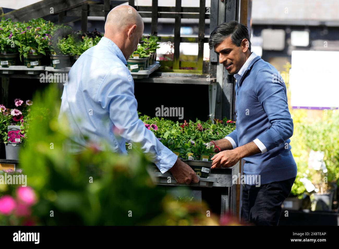 Britain's Prime Minister Rishi Sunak is shown plants in a Garden Centre ...