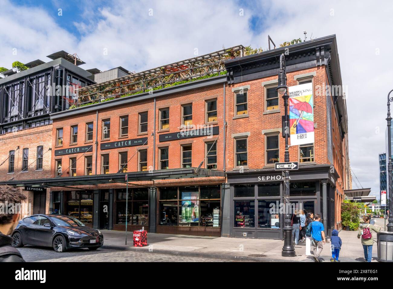 New York, NY - US - May 19, 2024 Tourists walk pass the red brick Catch ...