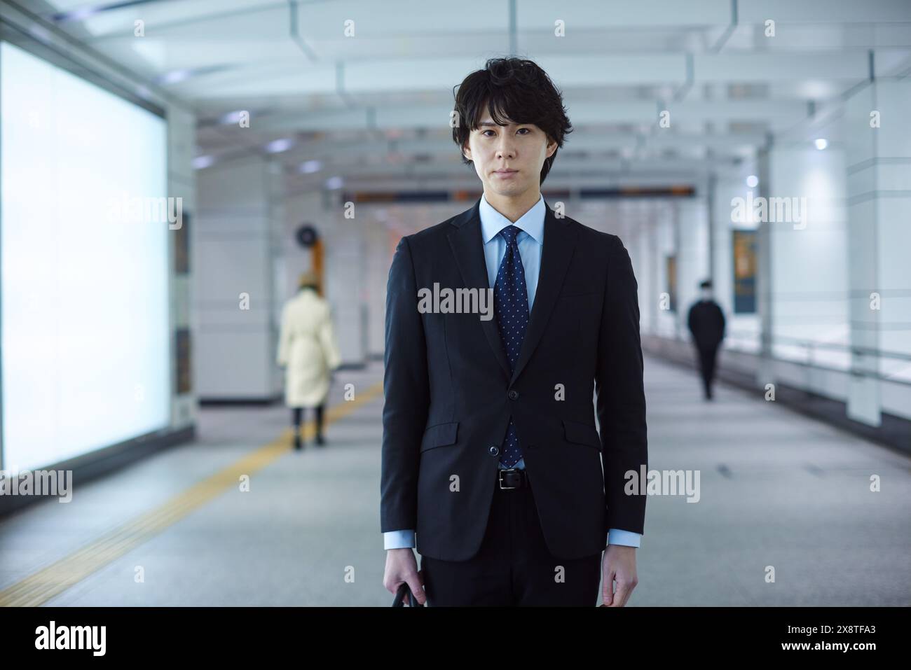 Japanese man in a suit stands in an empty subway station Stock Photo ...