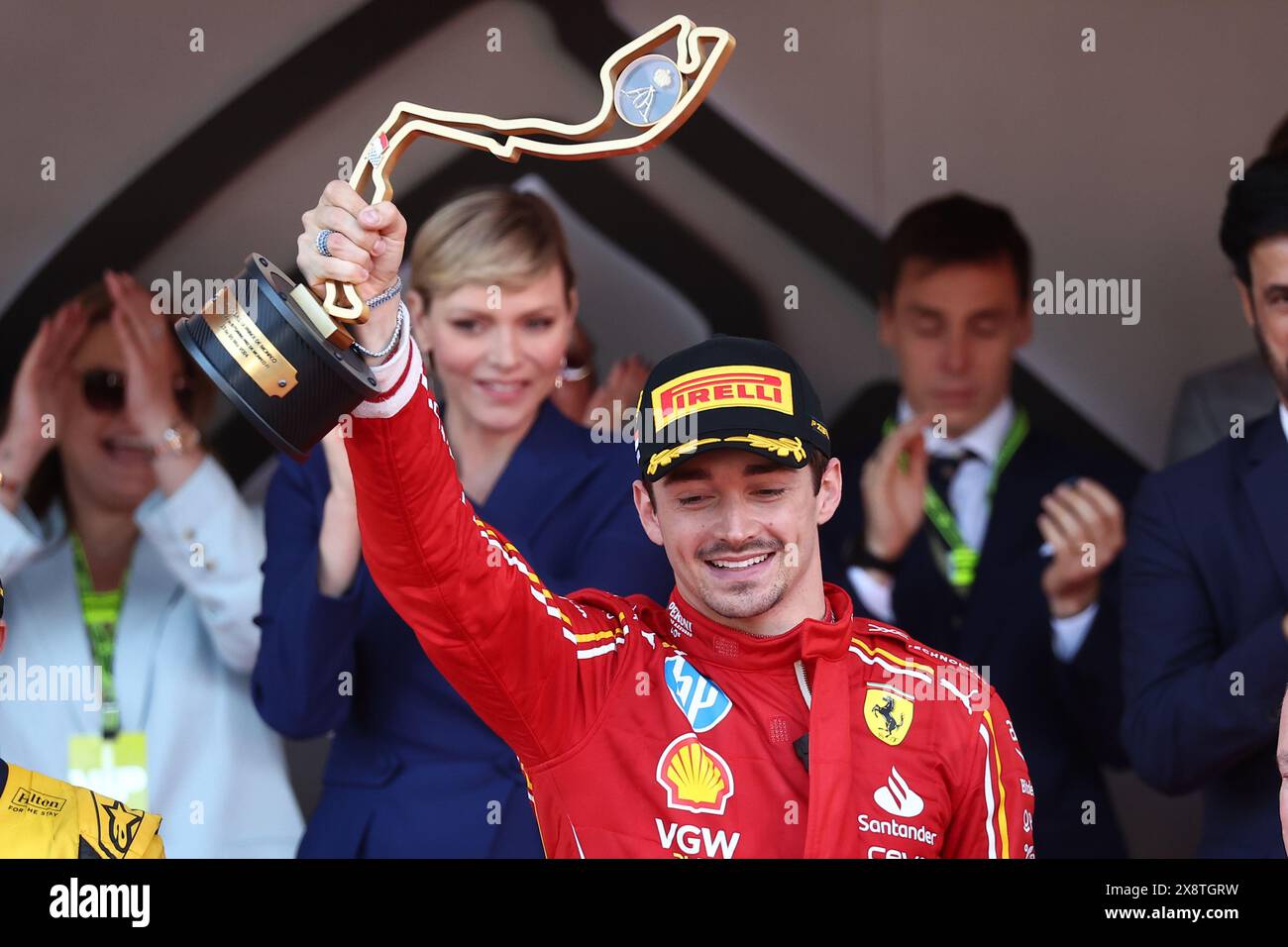 Charles Leclerc of Scuderia Ferrari celebrates victory with the trophy ...
