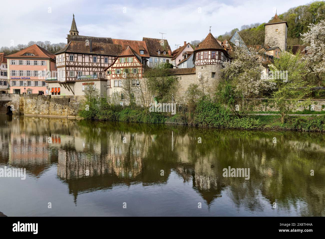 River Kocher with the reflection on the water of the Henkersbruecke, the half-timbered house and ...
