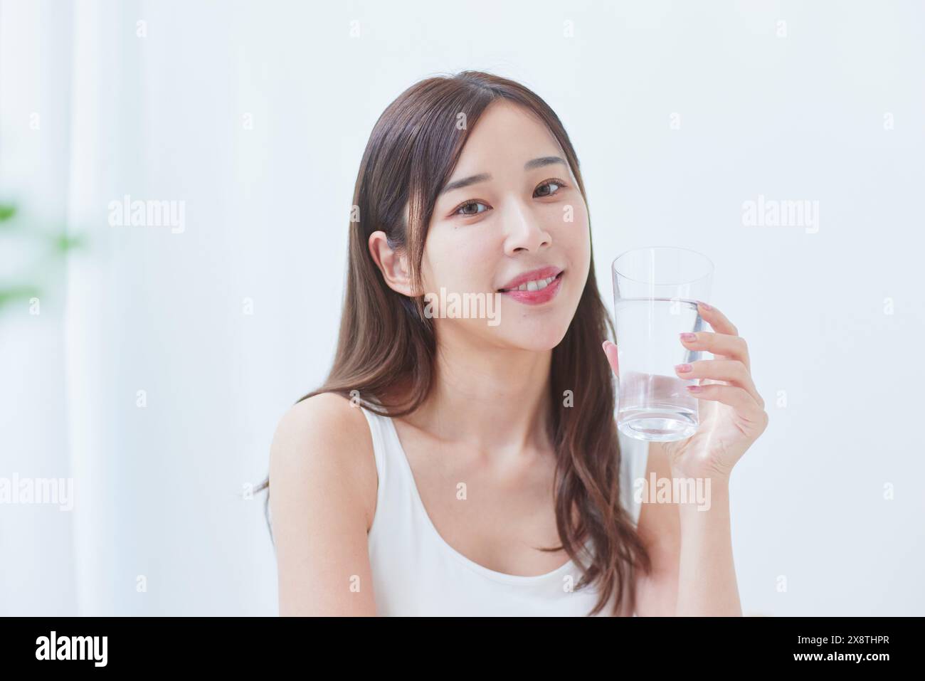 Japanese woman drinking water from glass Stock Photo - Alamy