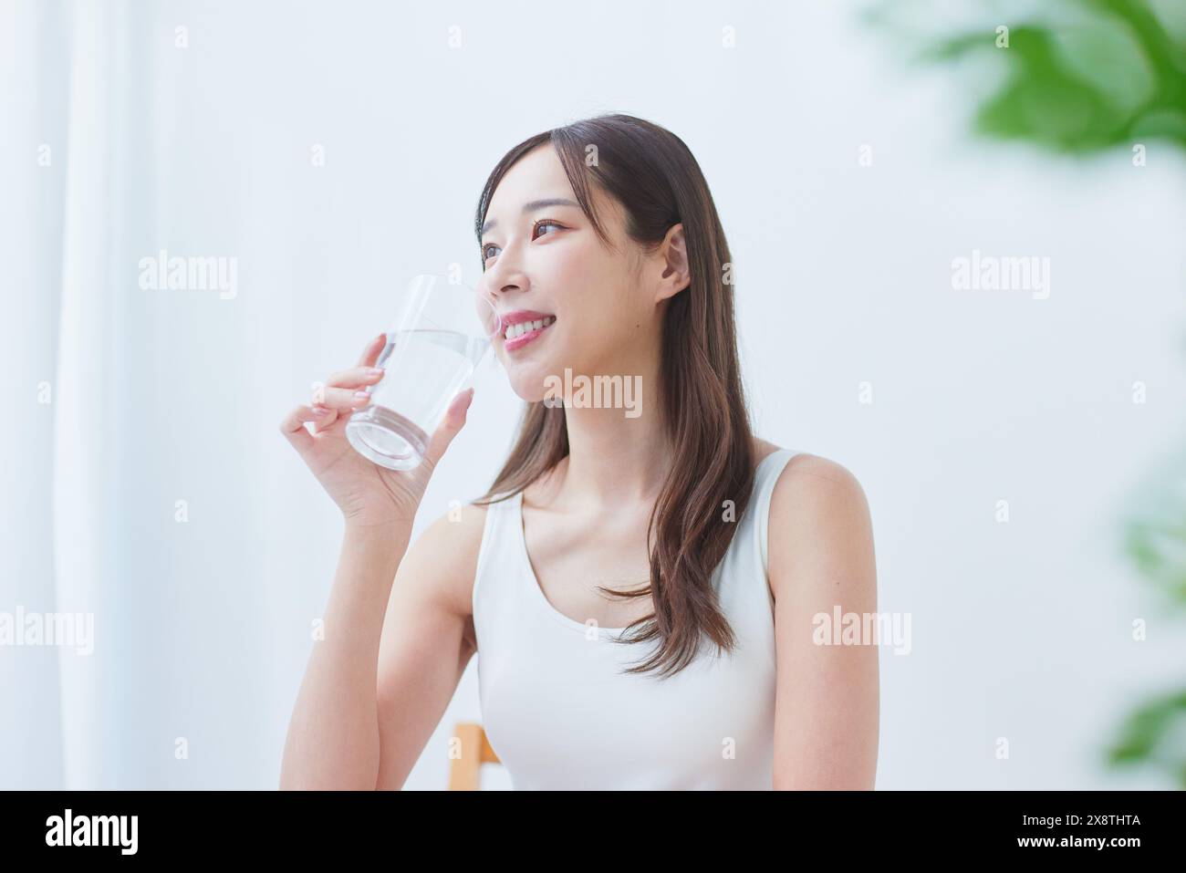 Japanese woman drinking water from glass Stock Photo - Alamy