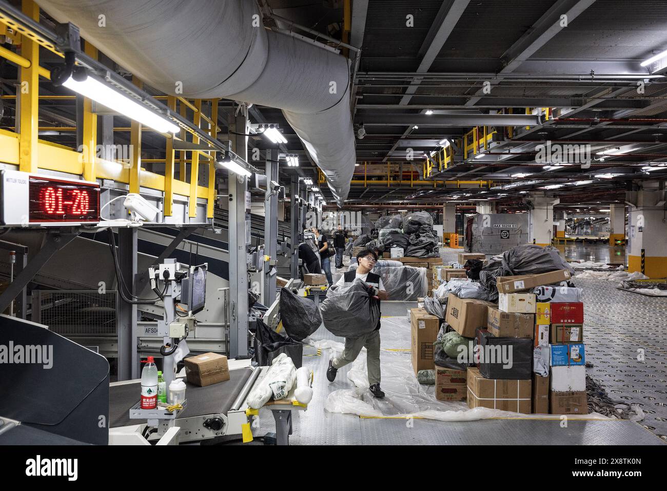 A staff member of SF airlines sorts parcels at the SF transfer center ...