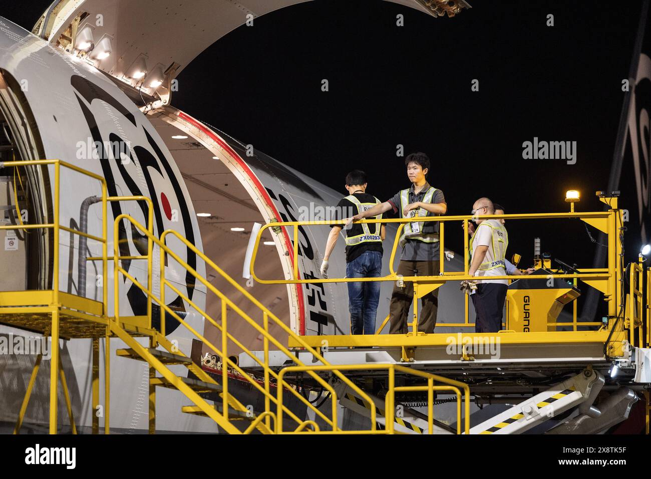 Staff members of SF airlines take a rest during loading the cargo onto ...