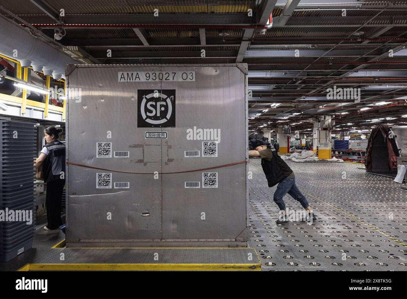 Staff members of SF airlines sort parcels at the SF transfer center of ...