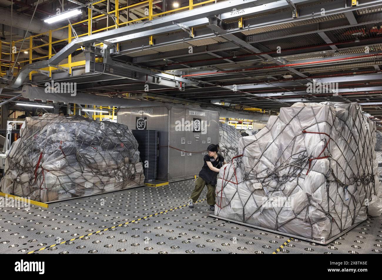 A staff member of SF airlines sorts parcels at the SF transfer center ...
