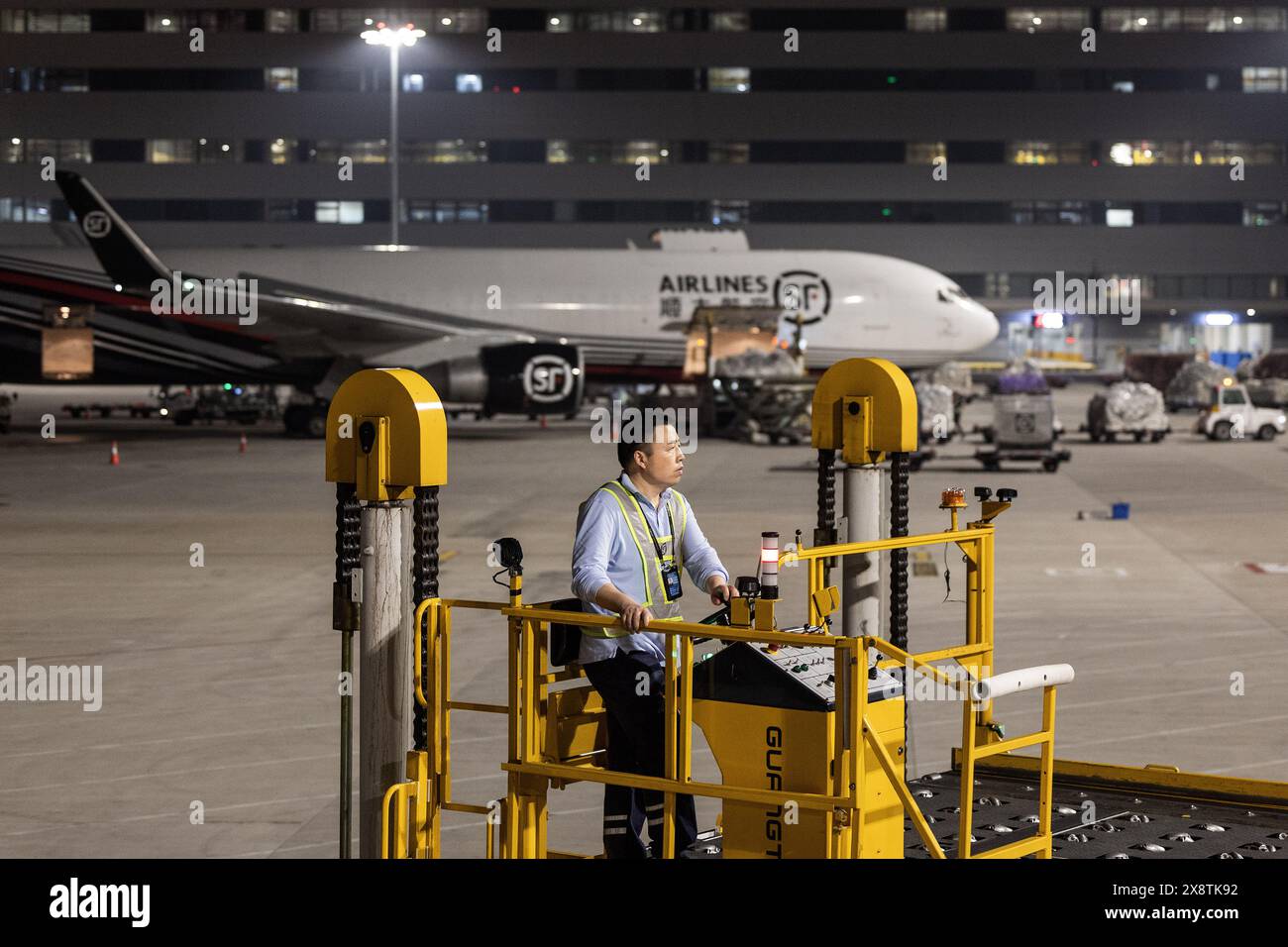 A staff member of SF airlines loads the cargo onto a SF cargo aircraft ...
