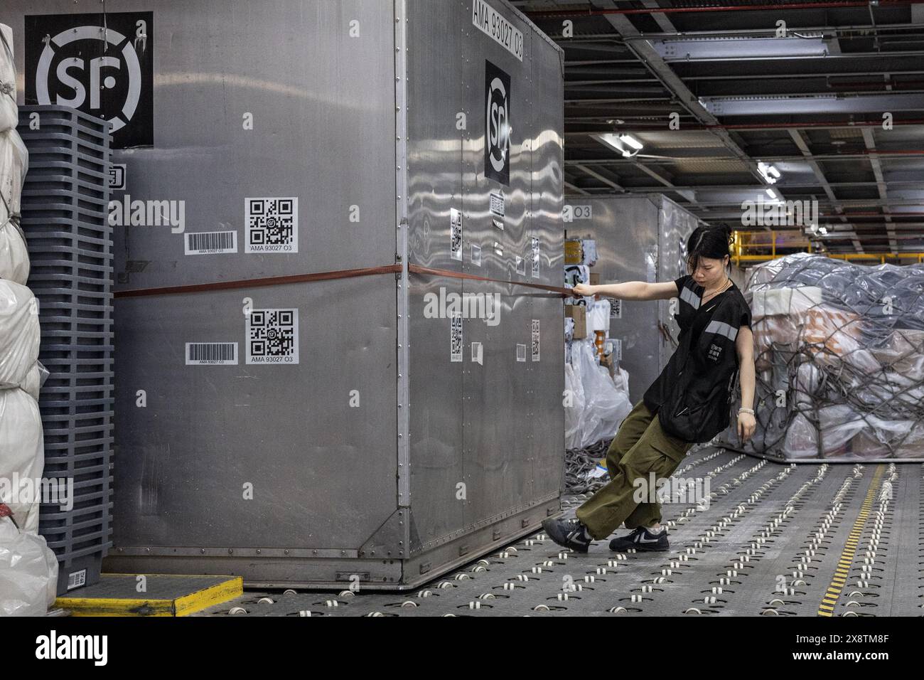 A staff member of SF airlines sorts parcels at the SF transfer center ...